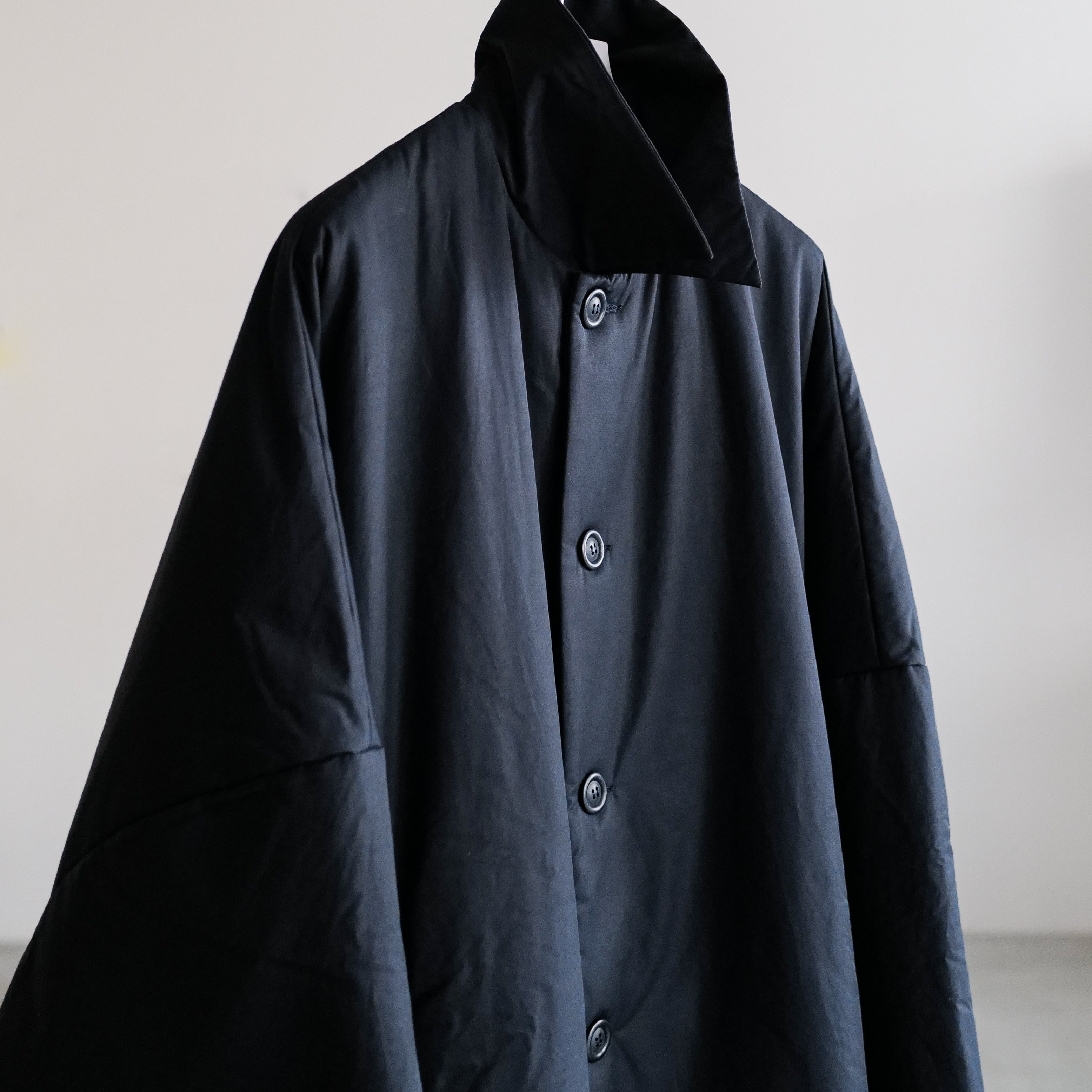 TRIANGLE COAT – ABOUT